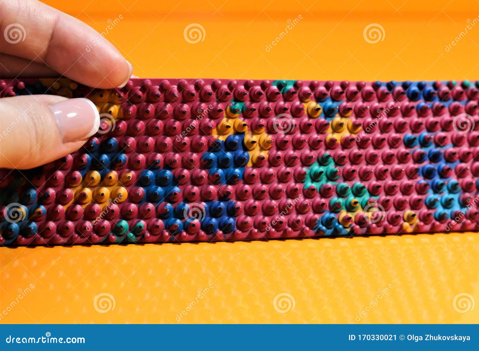 Massager Mat with Needles from Different Metals in Hand Stock Image ...