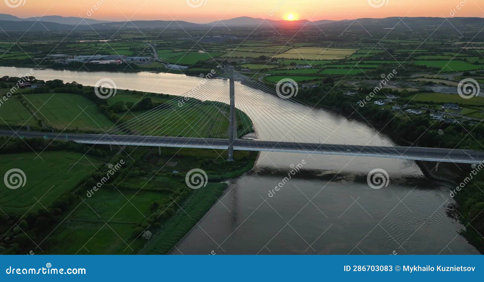 The Massive Cable-stayed Bridge Over the Suir River Against the Sunset ...