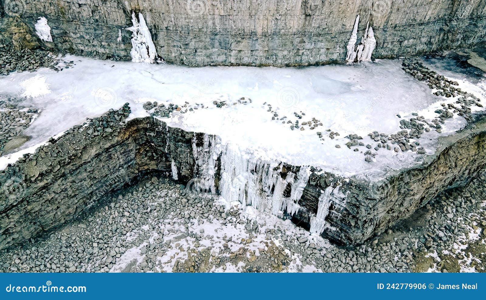 A Massive Cut Out at a Rock Quarry in Winter with Snow Melting Stock ...