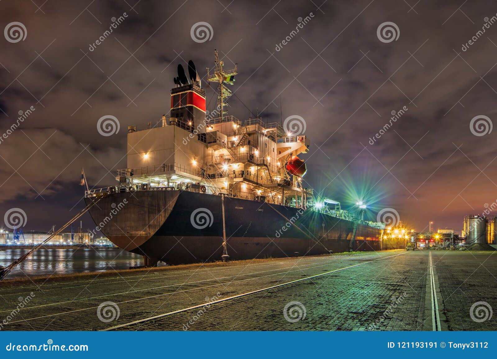 Moored Oil Tanker at Night with a Dramatic Cloudy Sky, Port of Antwerp ... Moored Oil Tanker at Night with a Dramatic Cloudy Sky, Port of Antwerp ...