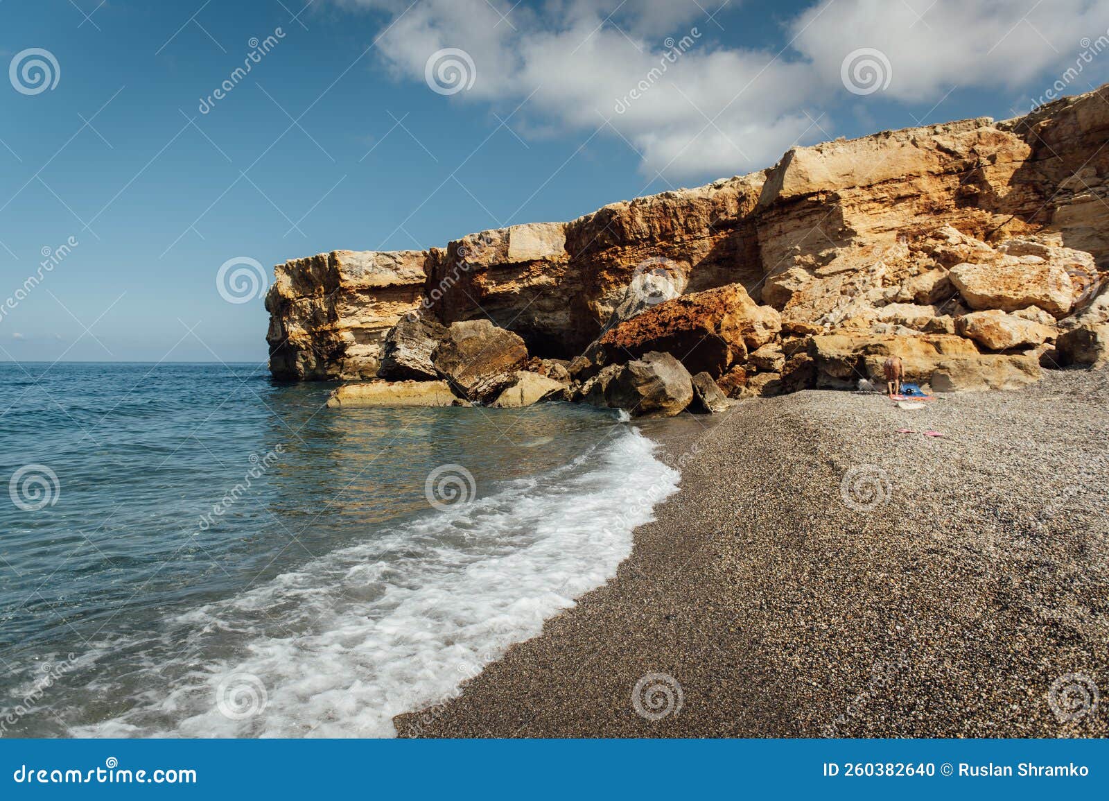 Massive Rocks Sink into the Water on a Pebble Beach Stock Photo - Image ...