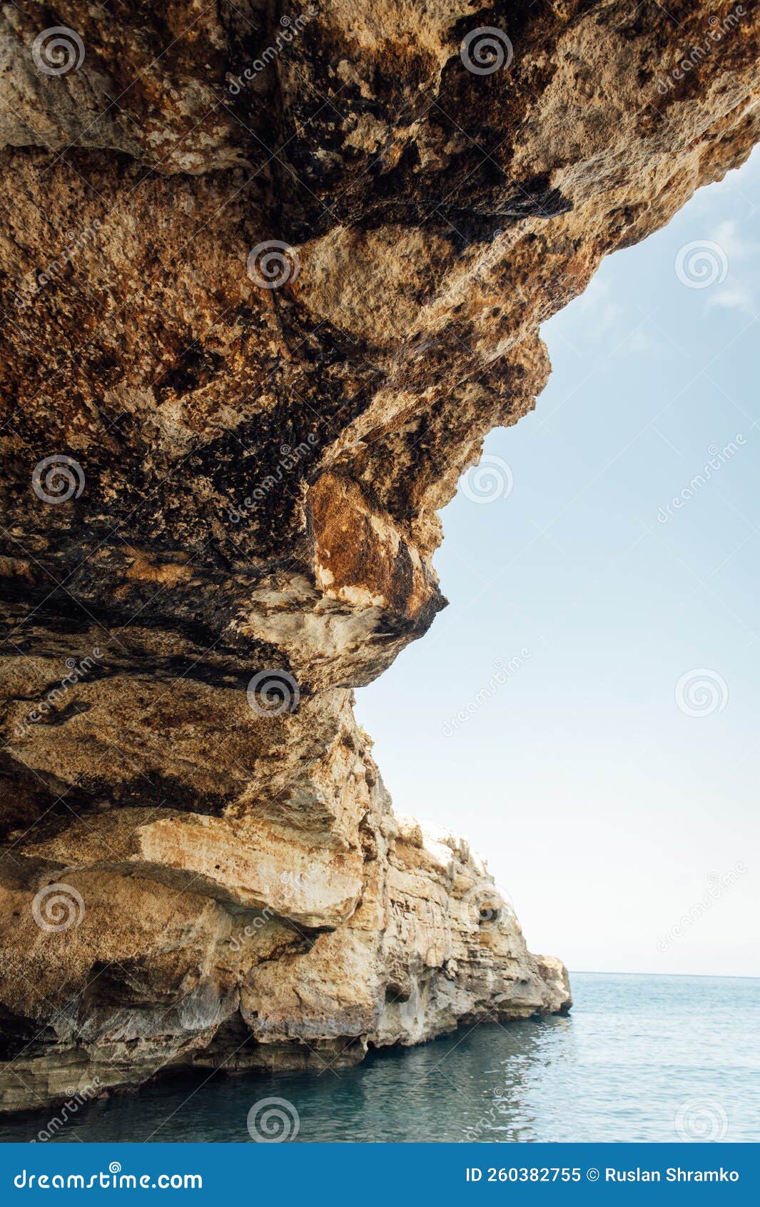 Massive Rocks Sink into the Water on a Pebble Beach Stock Image - Image ...