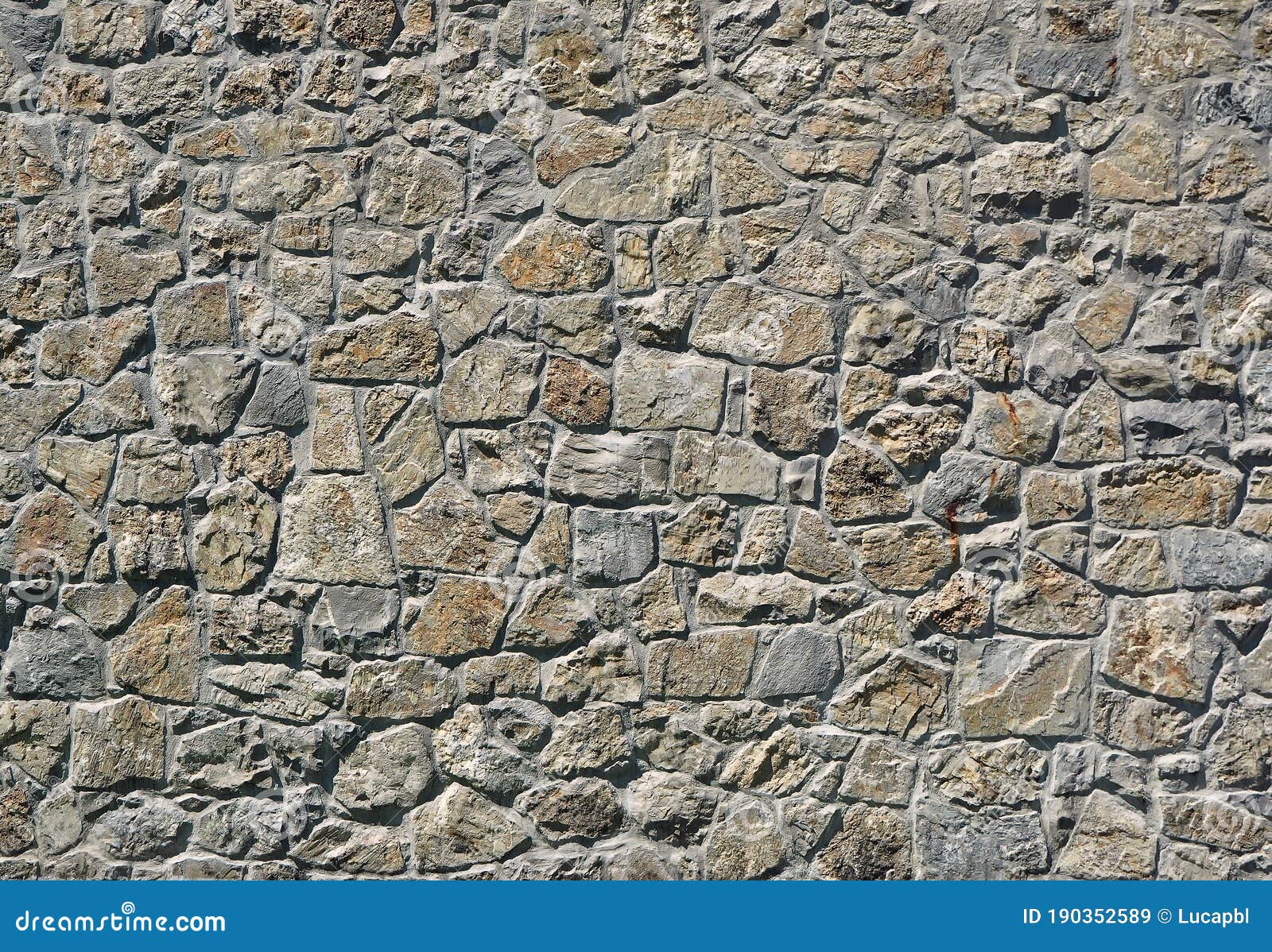 Massive Stone Wall Made of Gray and Brown Rocks with Irregular Shapes ...