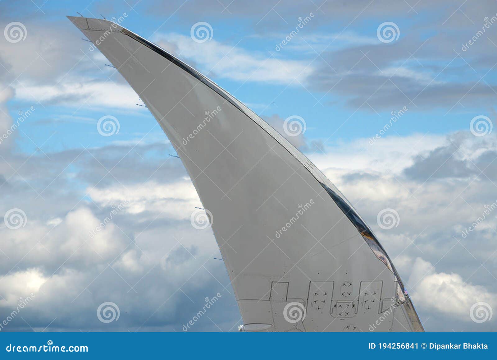 Massive Unmarked Airplane Folding Wingtips in Blue Sky with Clouds ...