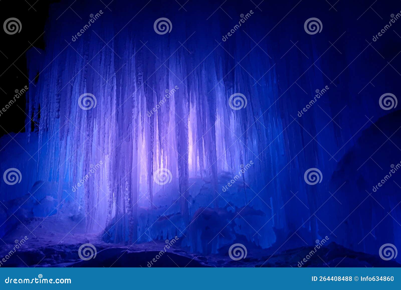 A Massive Wall of Long Ice Stalactites are Illuminated by a Few Rays of ...