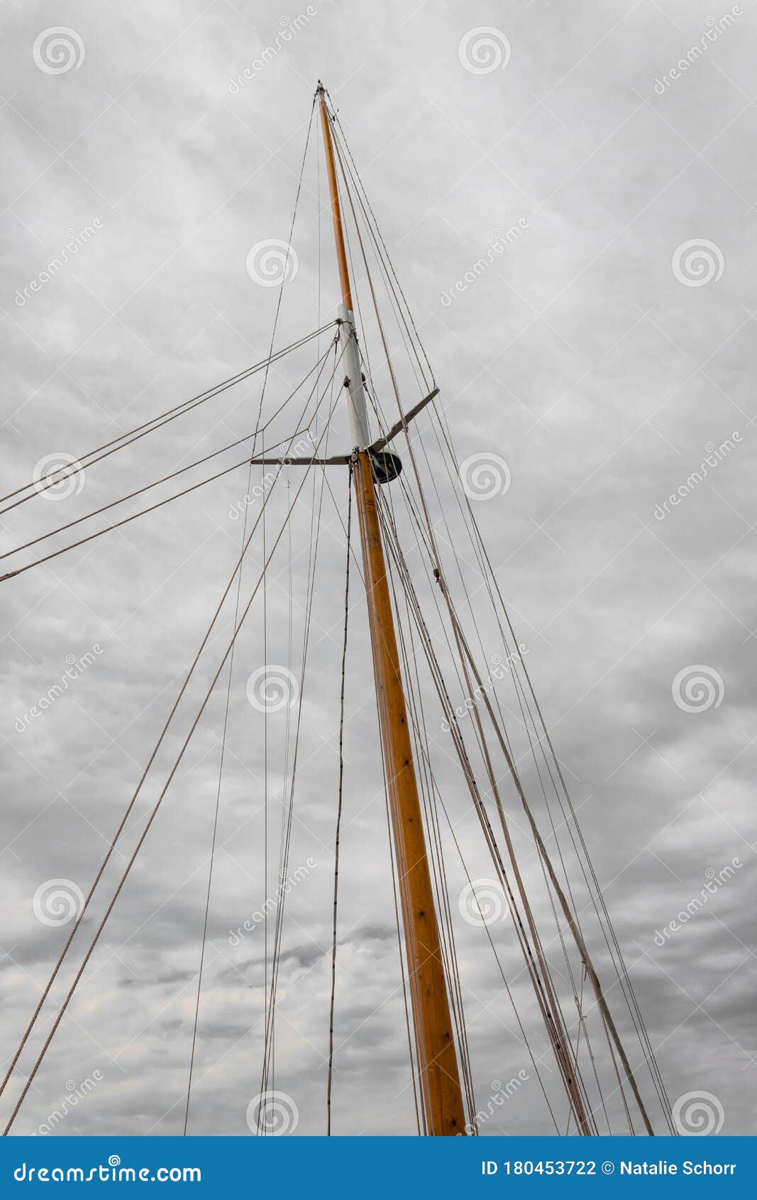 Mast of an Old Sailing Ship with Multiple Rigging Lines Against a Cold ...