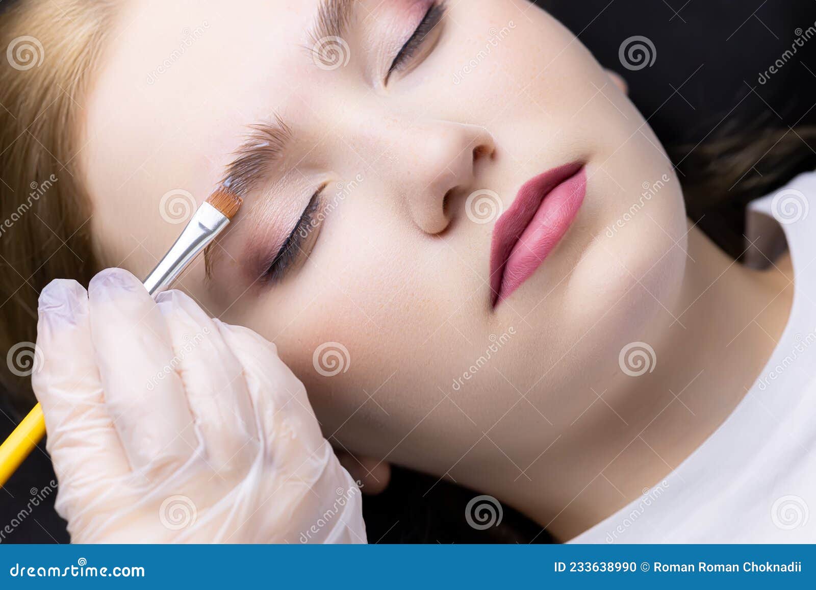 The Master Applies An Eyebrow Mask To The Client Using A Tattoo Machine ...