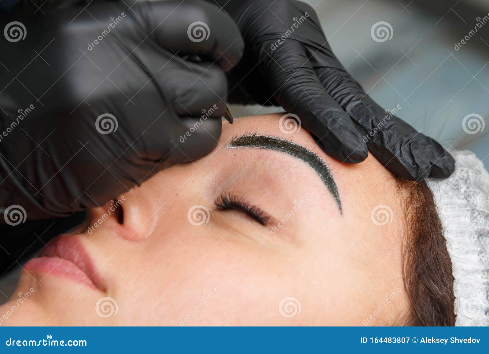 The Master Applies an Eyebrow Mask To the Client Using a Tattoo Machine ...