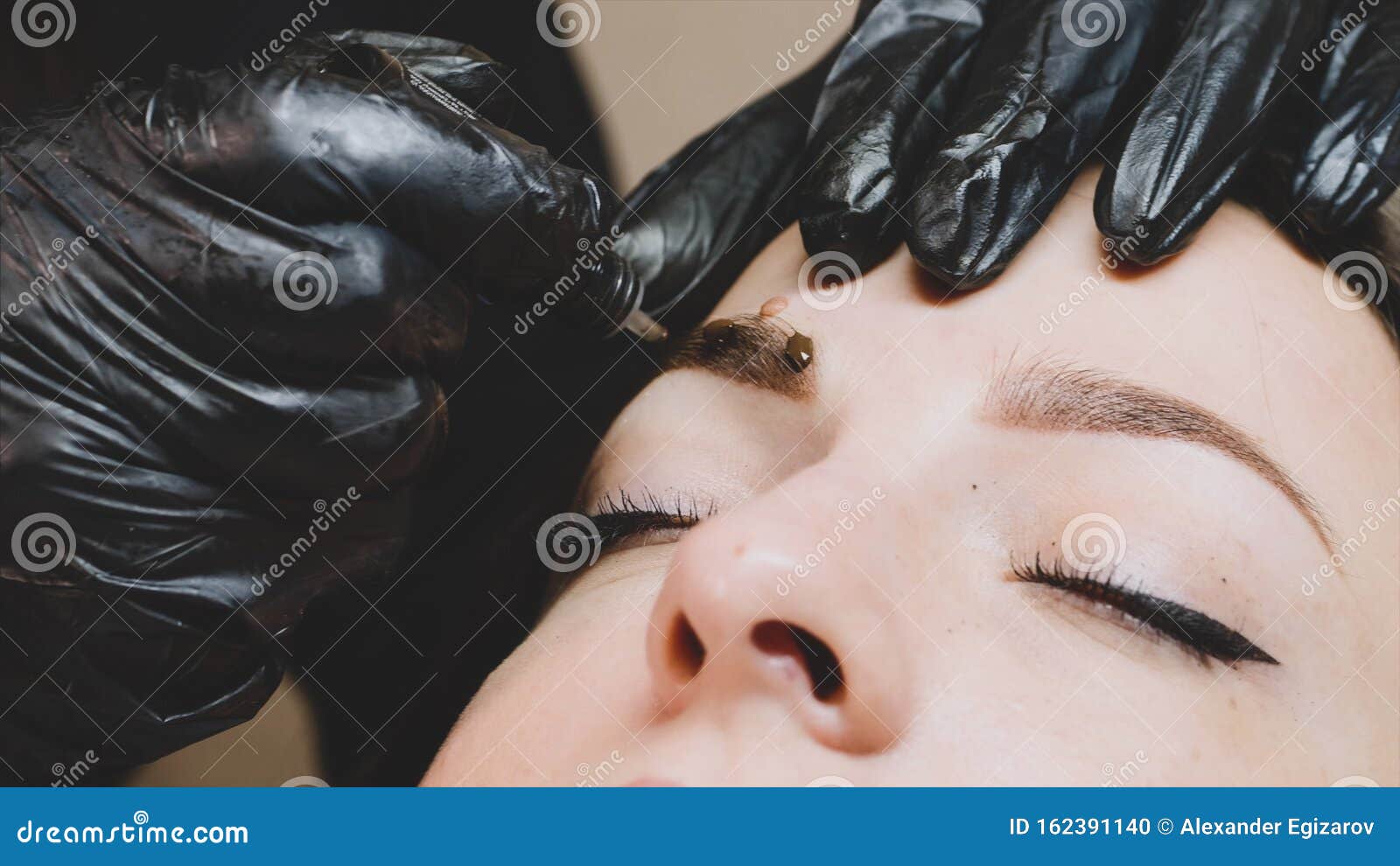 The Master is Adding Some Drops of the Brown Pigment on the Client`s ...