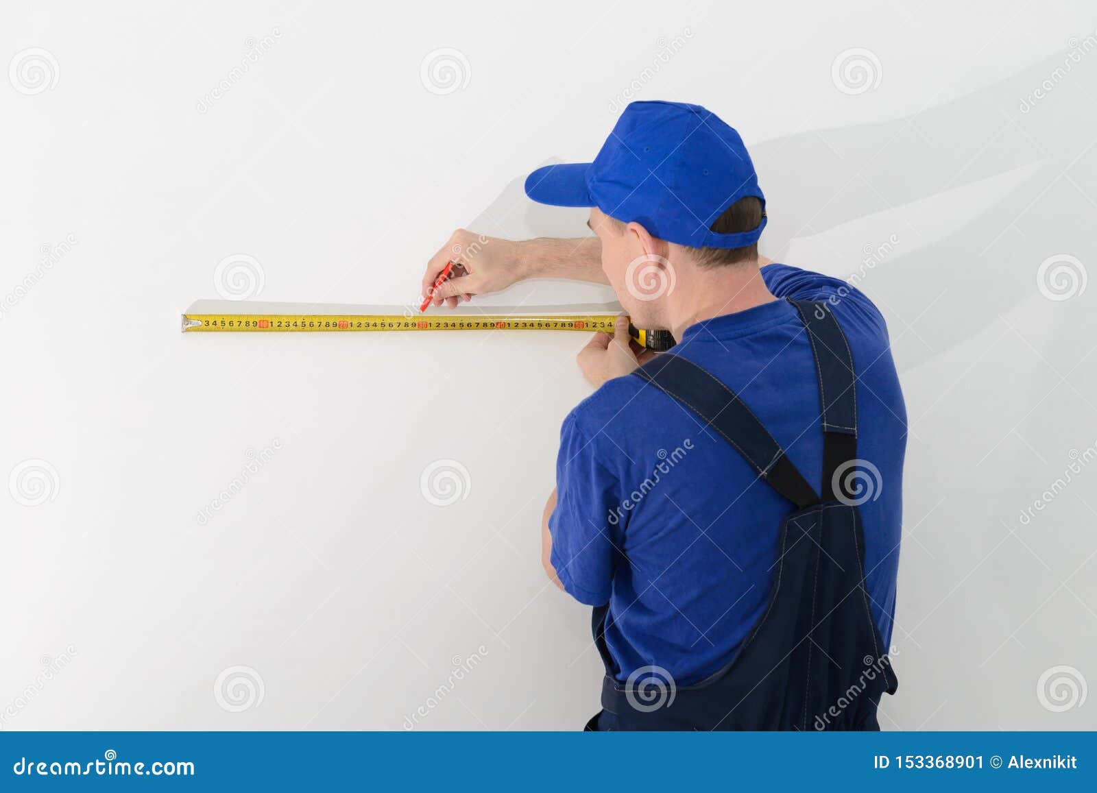 Master Builder in Uniform of Measuring Distances on Wall with a Tape ...
