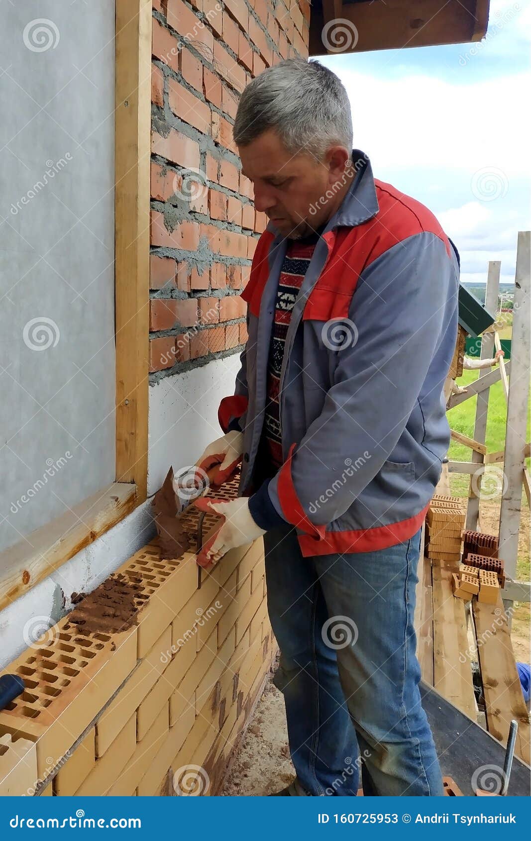 The Master Builds a Wall of a House from a Front Brick Stock Image ...