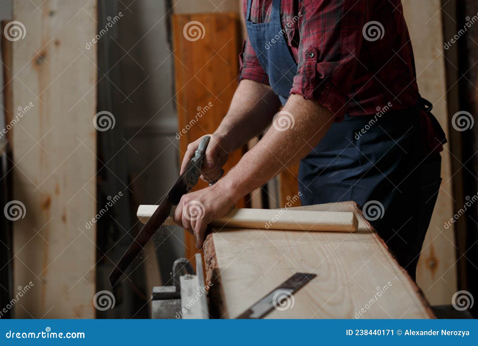 Master Carpenter Saws Board with Hacksaw in Workshop. Close Up Stock ...