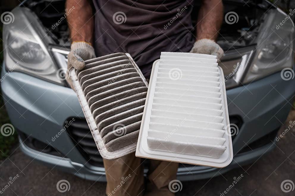 The Master Changes the Air Filter in the Car Engine. Stock Photo ...