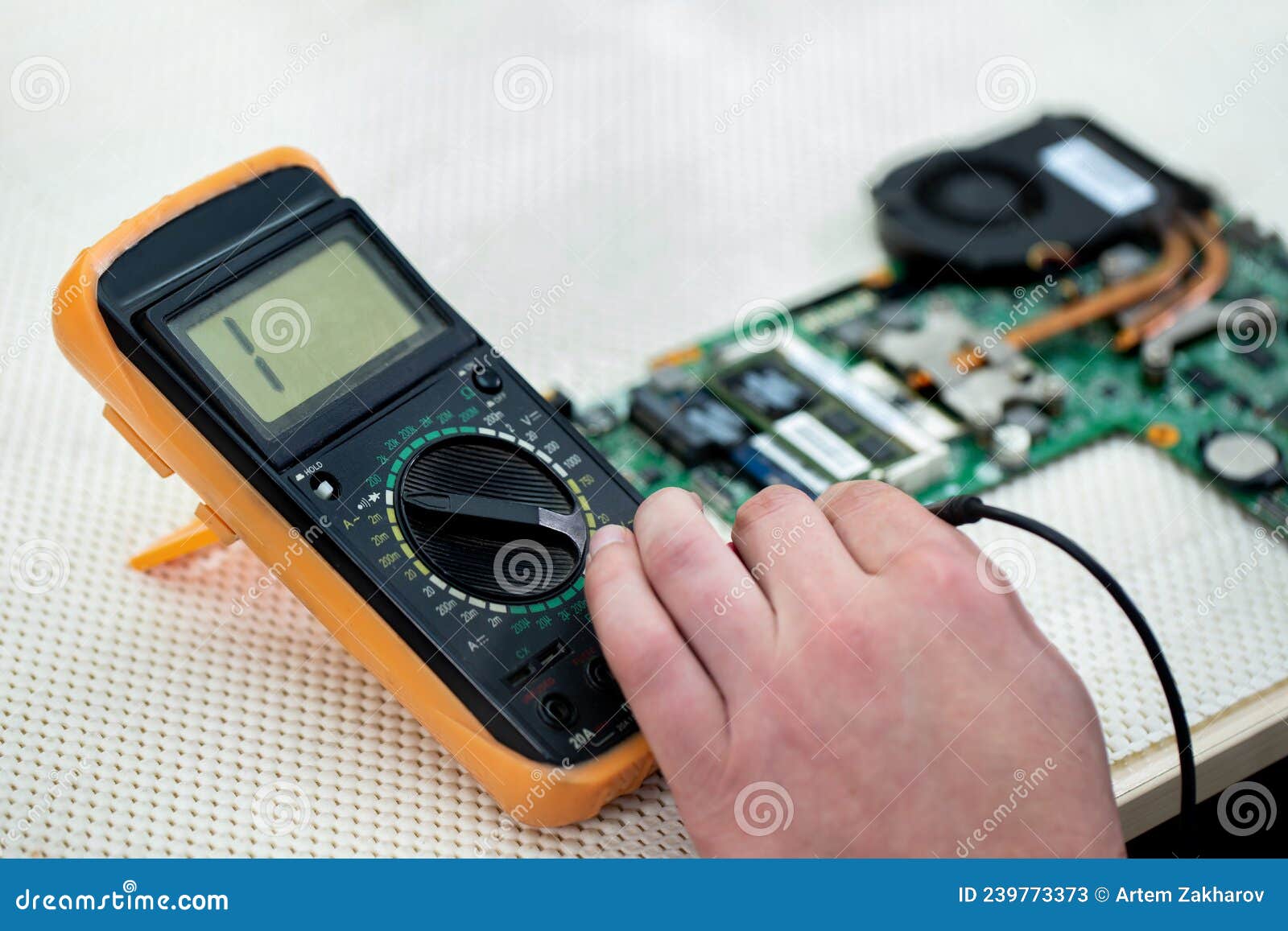 The Master Checks a Broken Laptop with a Multimeter. Stock Image ...