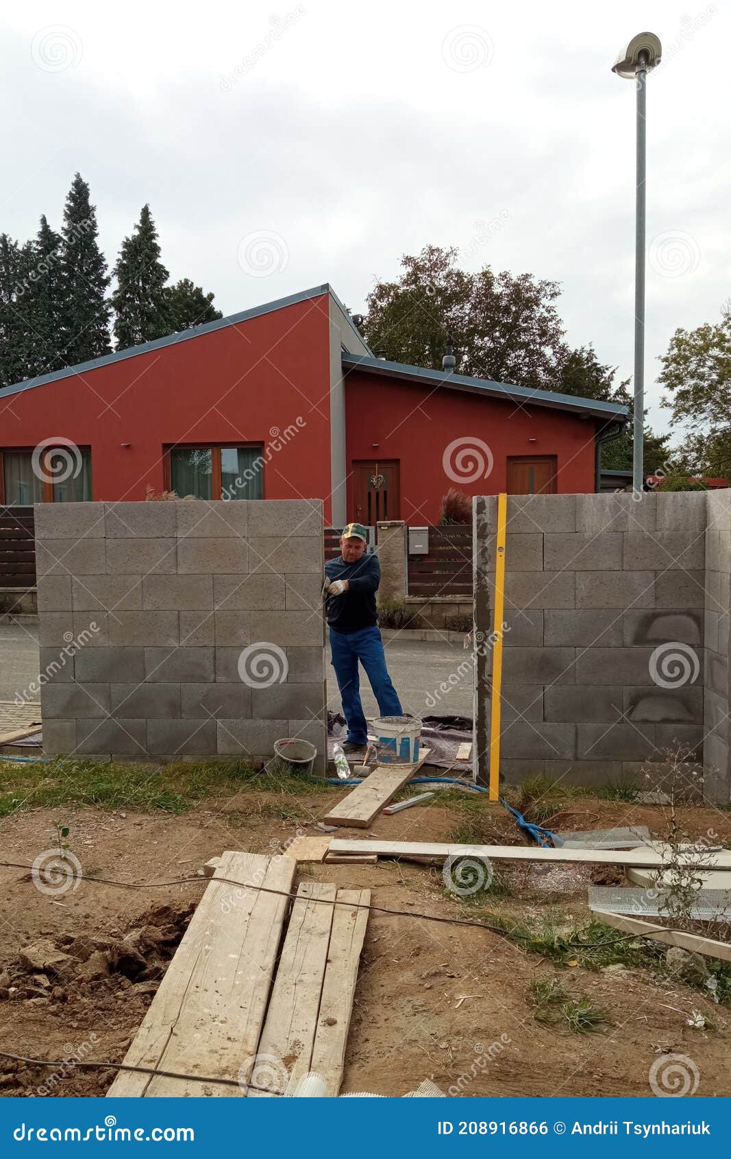 Master on the Construction Site Construction of a Fence on a Private ...