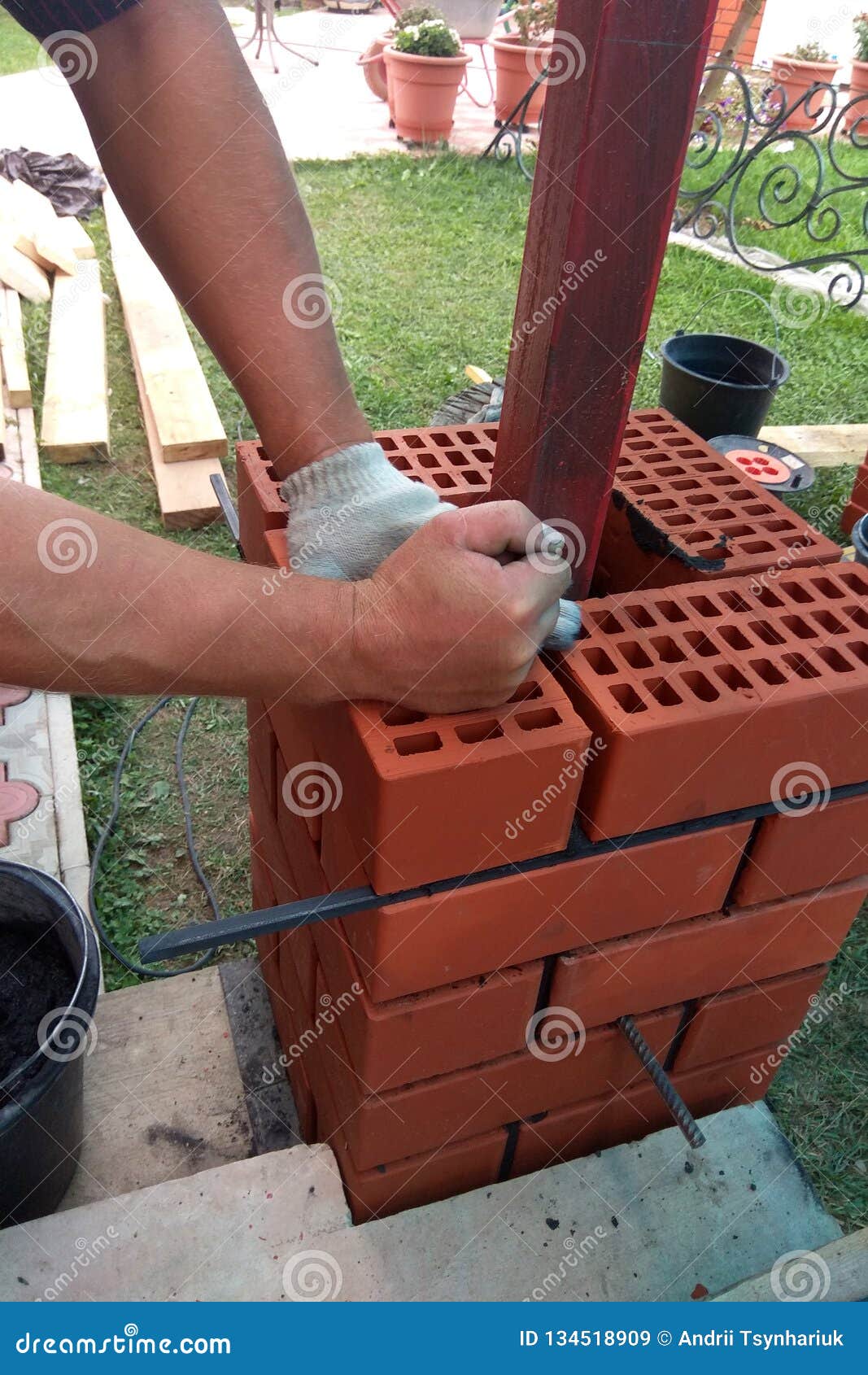 The Master at the Construction Site is Laying a Brick Laying Stock ...