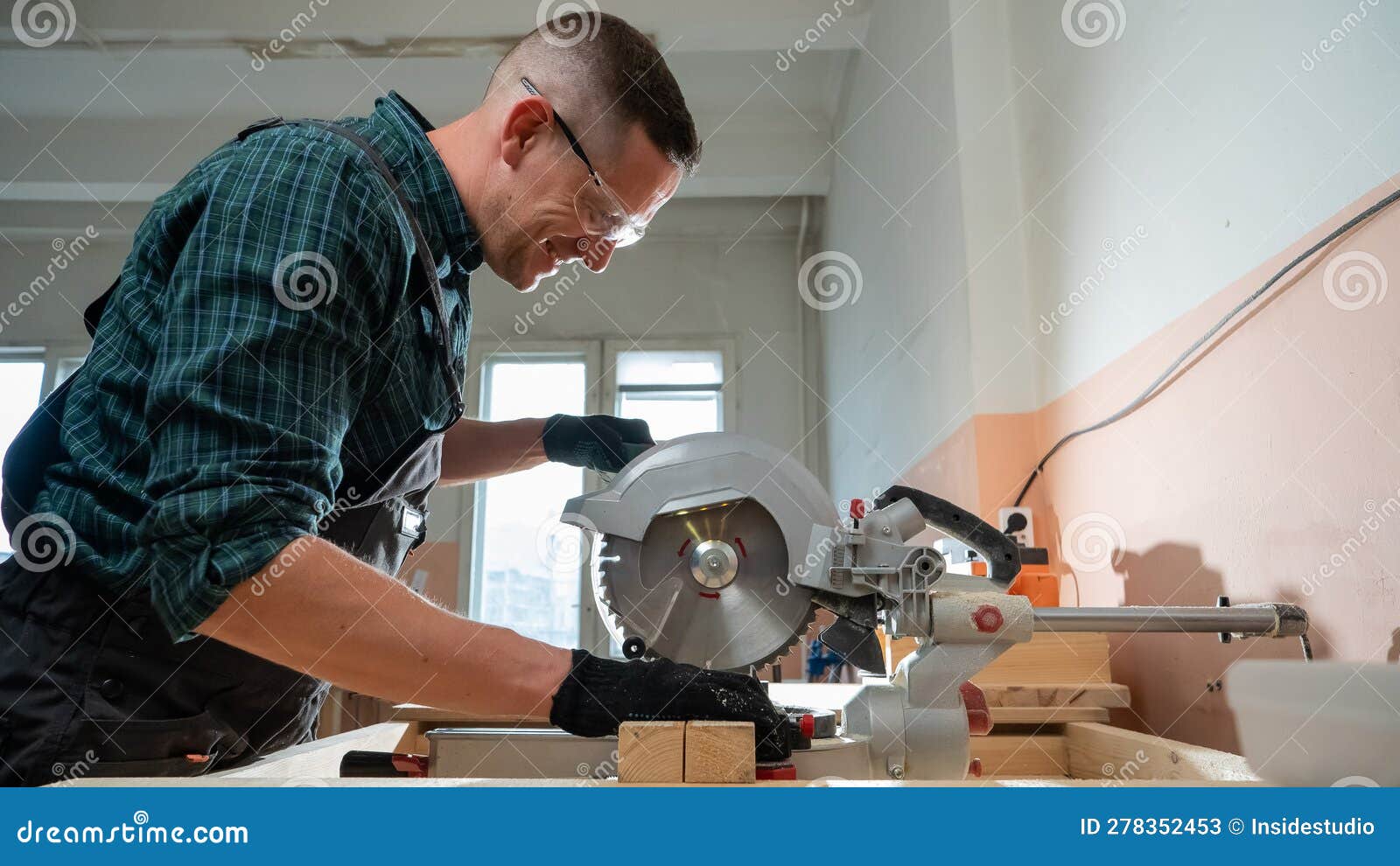 Master Cuts the Board with a Circular Saw in the Workshop. Stock Image ...