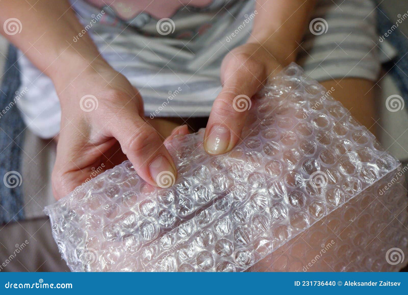 A Woman Bursts Bubbles in an Air Bubble Film. Antistress Stock Photo ...