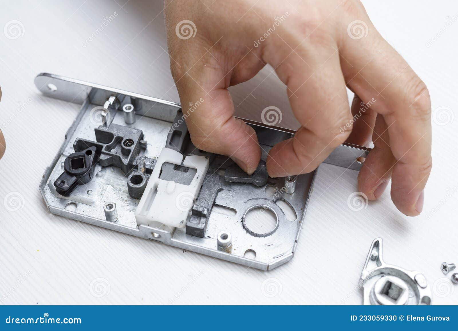 The Master Disassembles the Door Lock with a Screwdriver Stock Photo ...