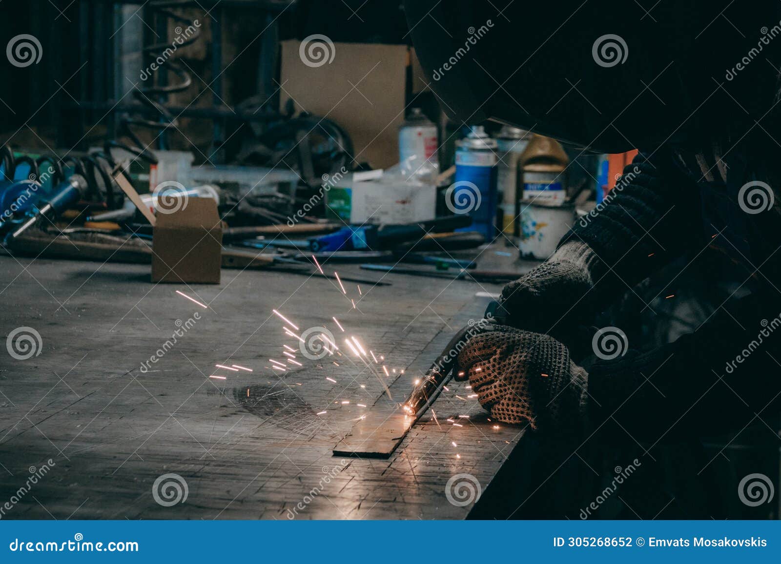 Master is Doing Welding at His Workplace in the Workshop, while Sparks ...