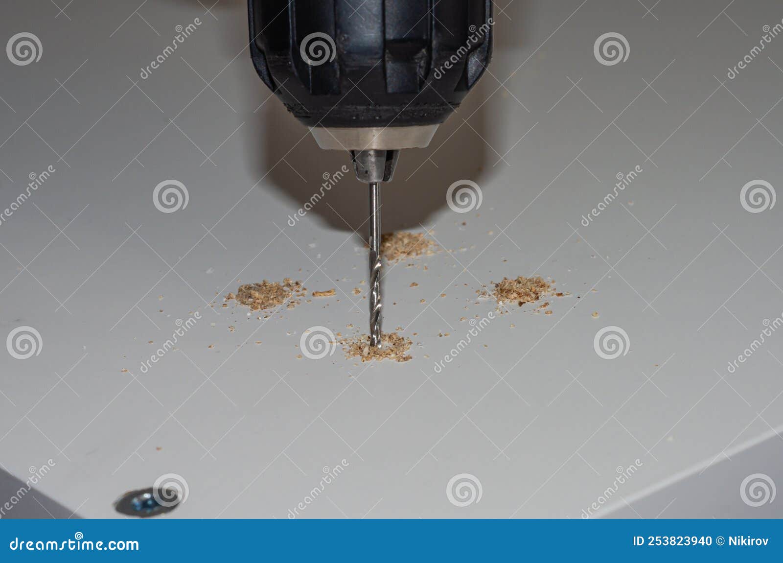 The Master Drills Four Holes in a Wooden Plate with a Drill Stock Photo ...