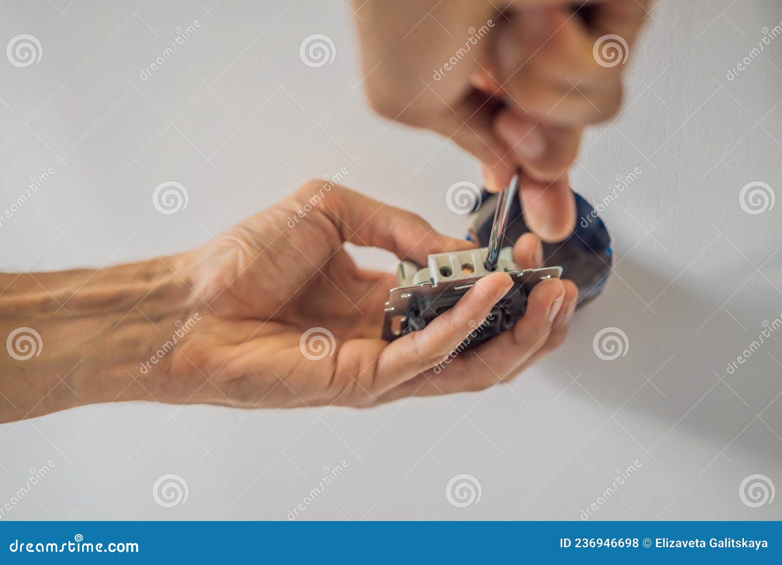 Master Electrician Installs a Socket in the House Stock Photo - Image ...
