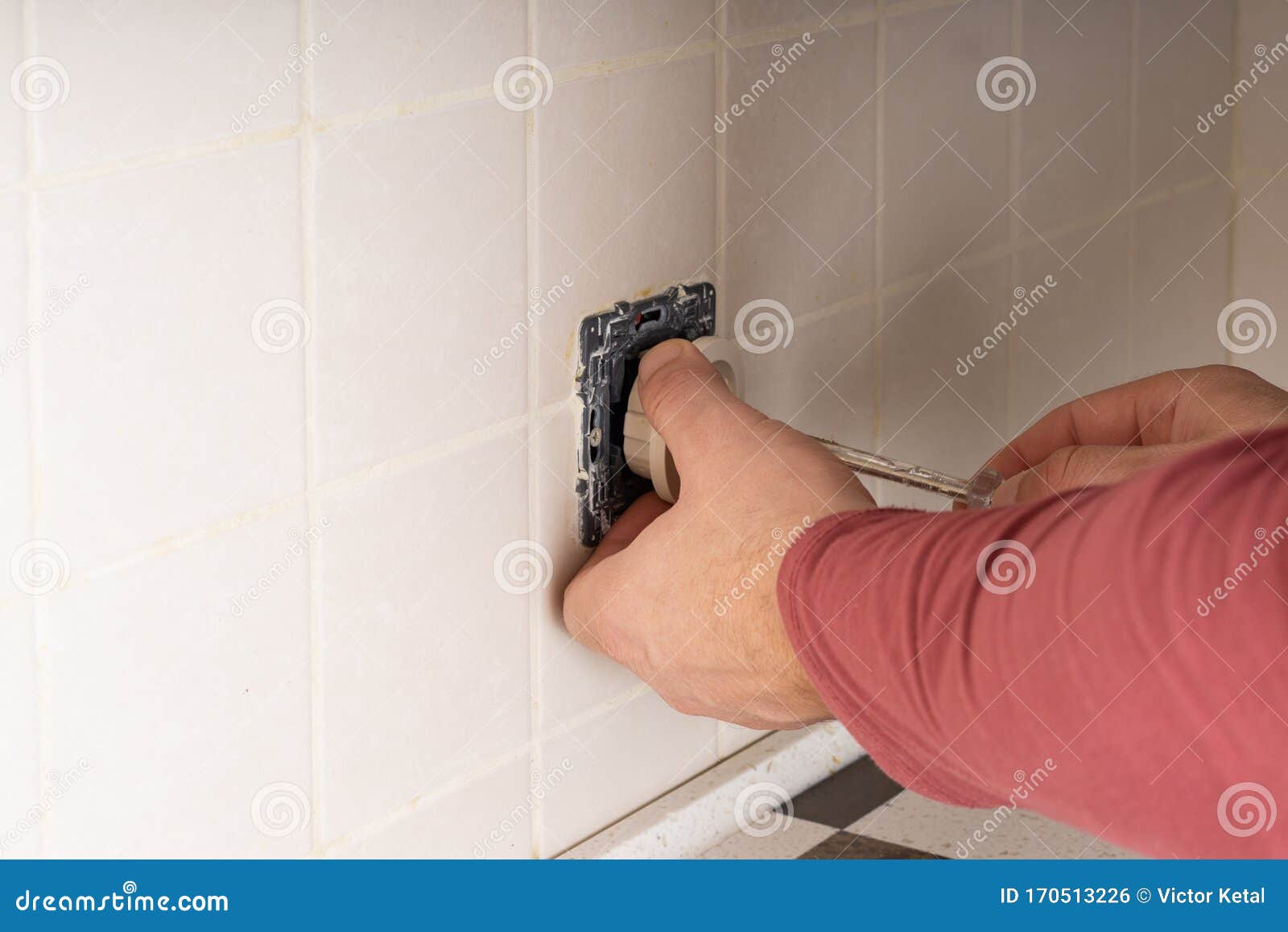 A Master Electrician Mounts an Electrical Plug on a Wall. Vintage ...