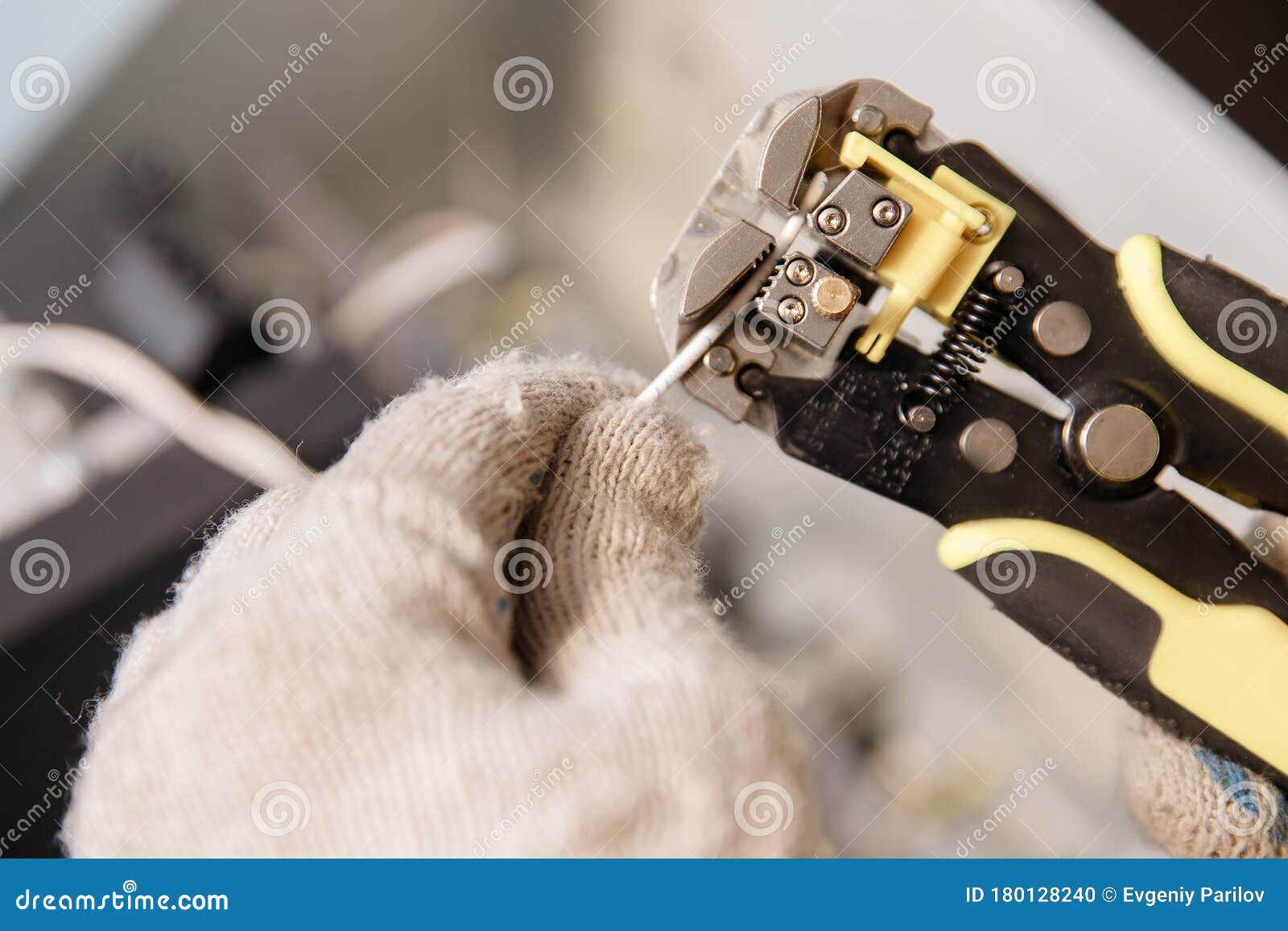 Master Electrician with Professional Tool for Removing Insulation from ...