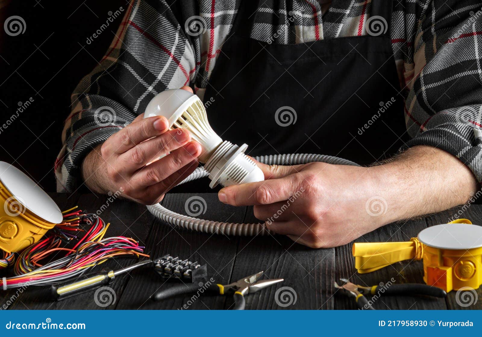 Master Electrician Turns on the Light Bulb. Closeup of Worker Hands on ...