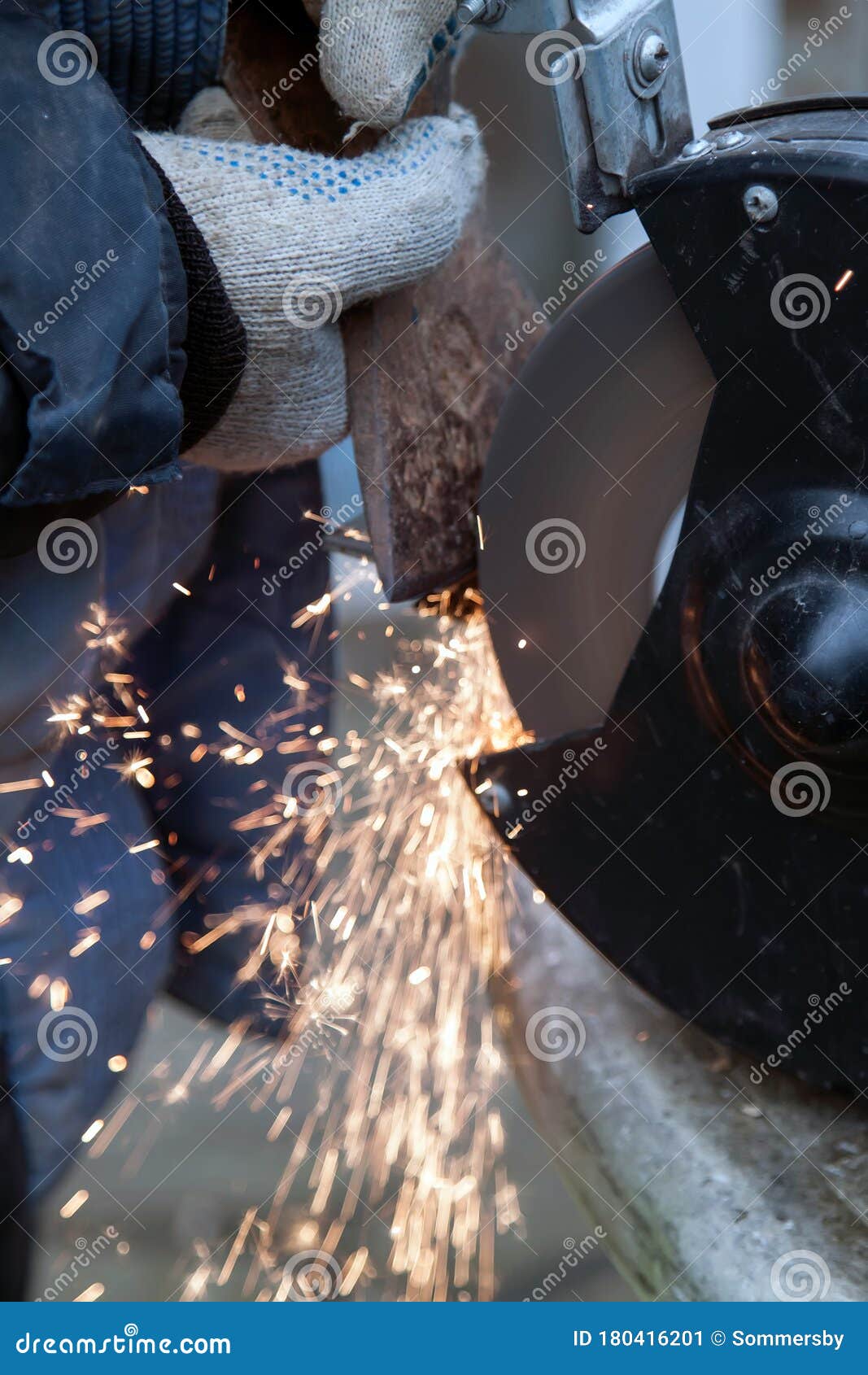 Master in Gloves and Blue Jacket Sharpens Axe on Electric Sharpener ...