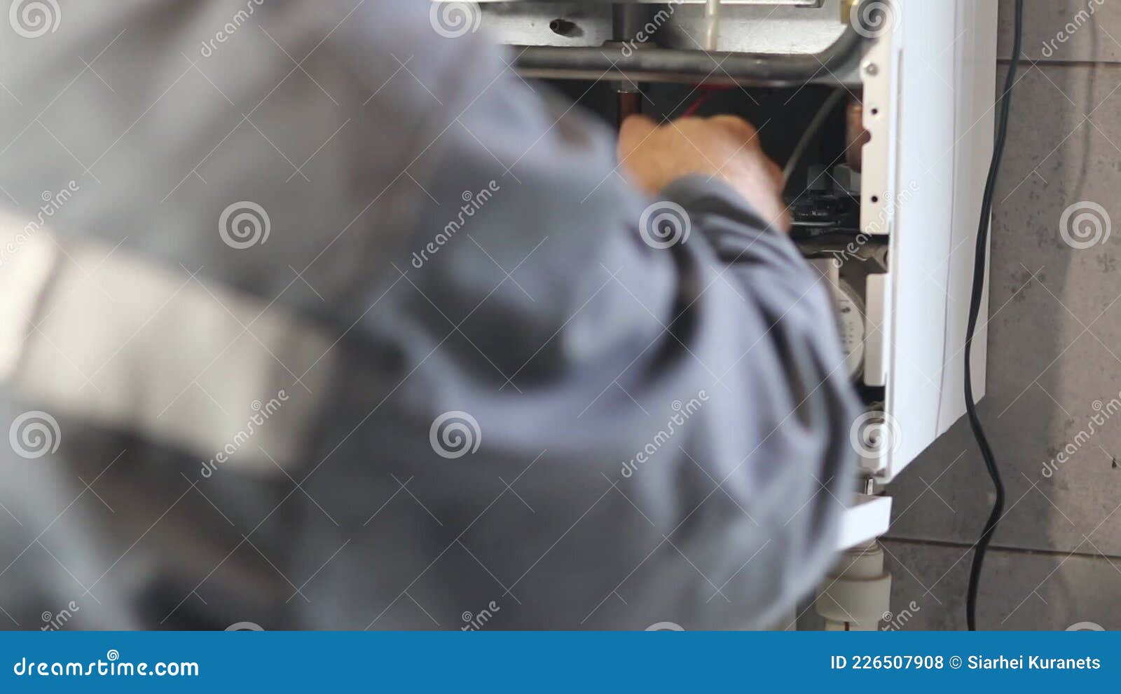 The Master Installs a Gas Boiler that Hangs on the Wall. the Front ...