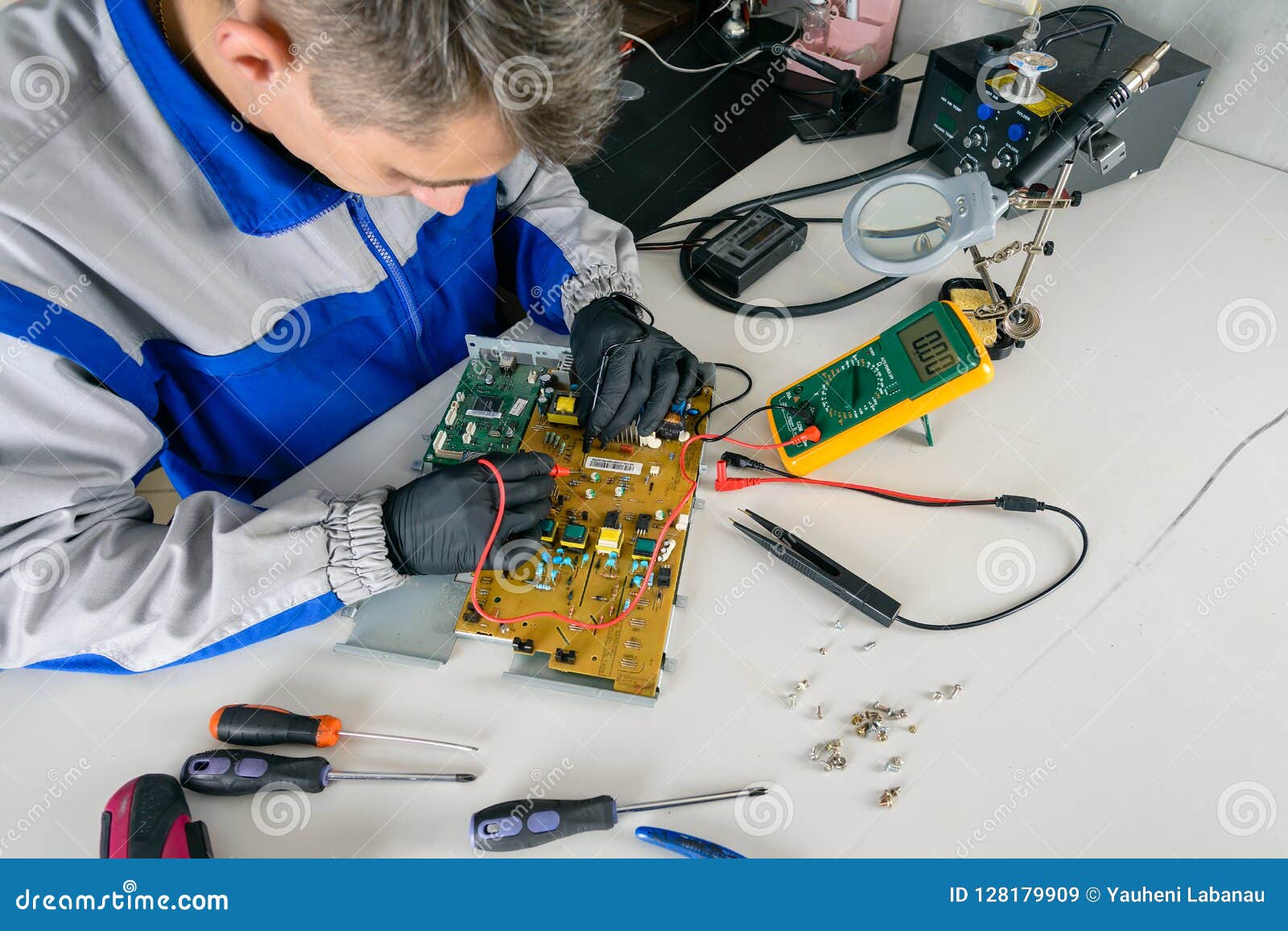 Master is Looking for Damage, Repair Office Equipment Using Multimeter ...