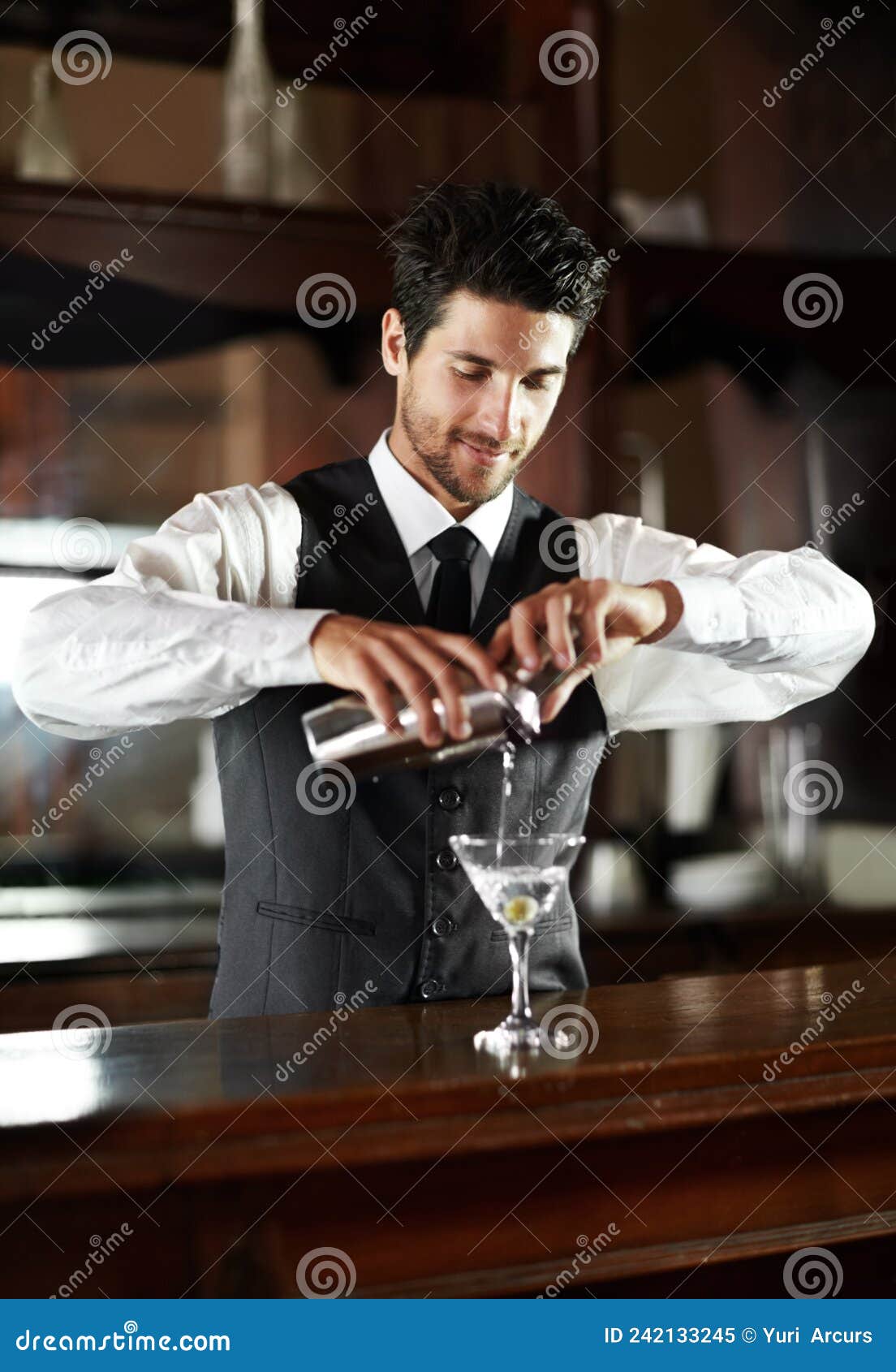 Master Mixologist. a Handsome Young Bartender Mixing a Cocktail for a ...