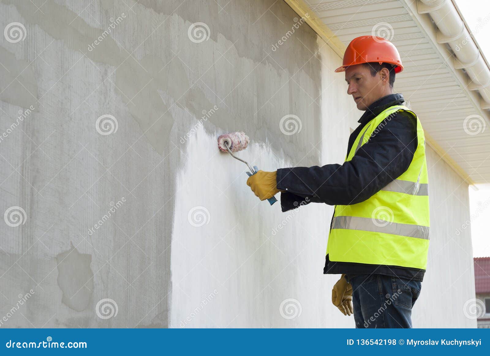 Master paints the wall stock photo. Image of craftsman - 136542198