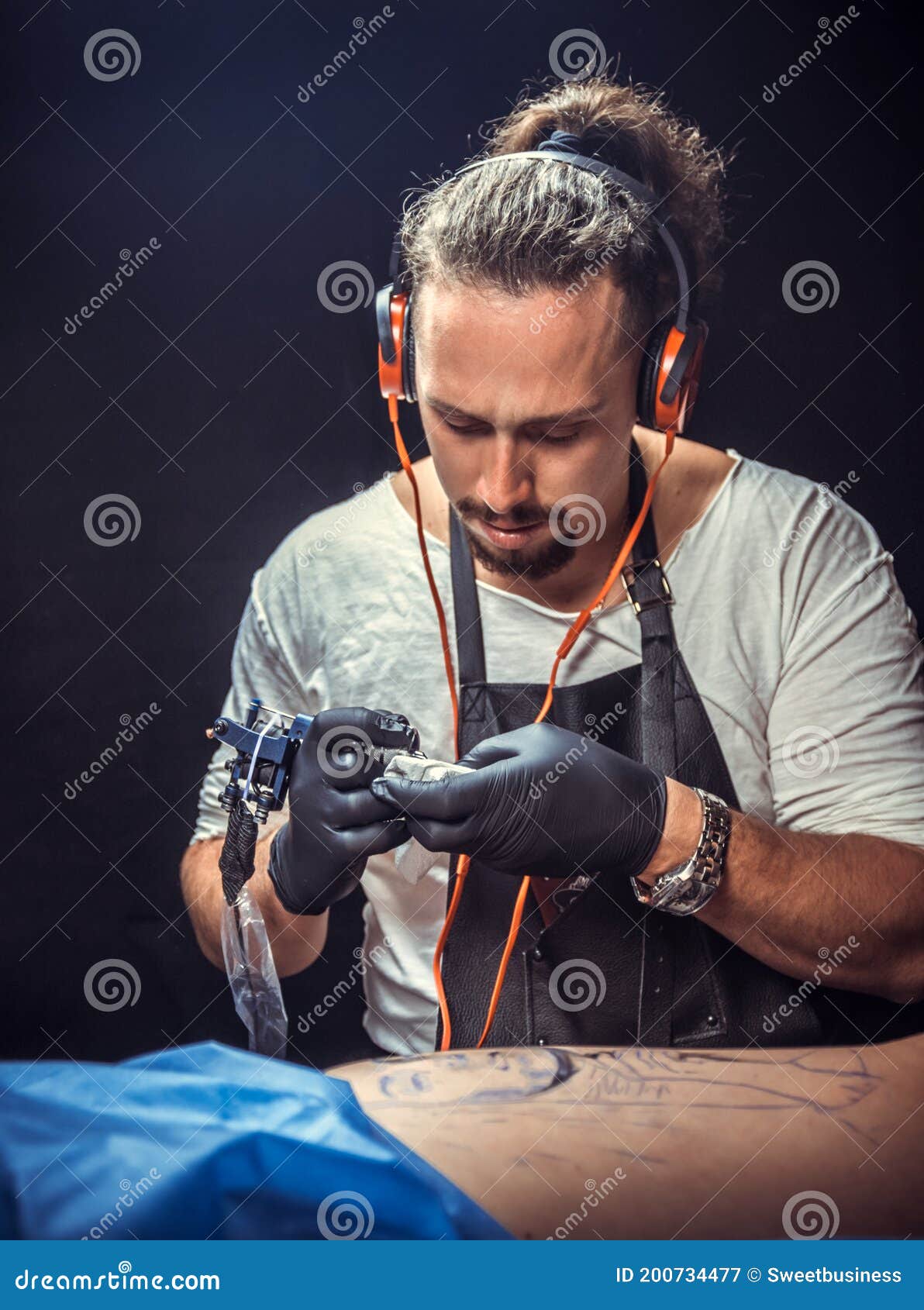 Master of the Art of Tattooing Demonstrates the Process of Getting ...