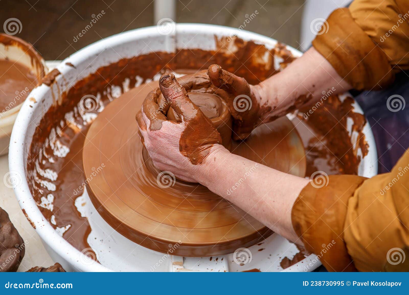 The Master of Pottery Makes Dishes from Brown Clay. Folk Art Stock ...