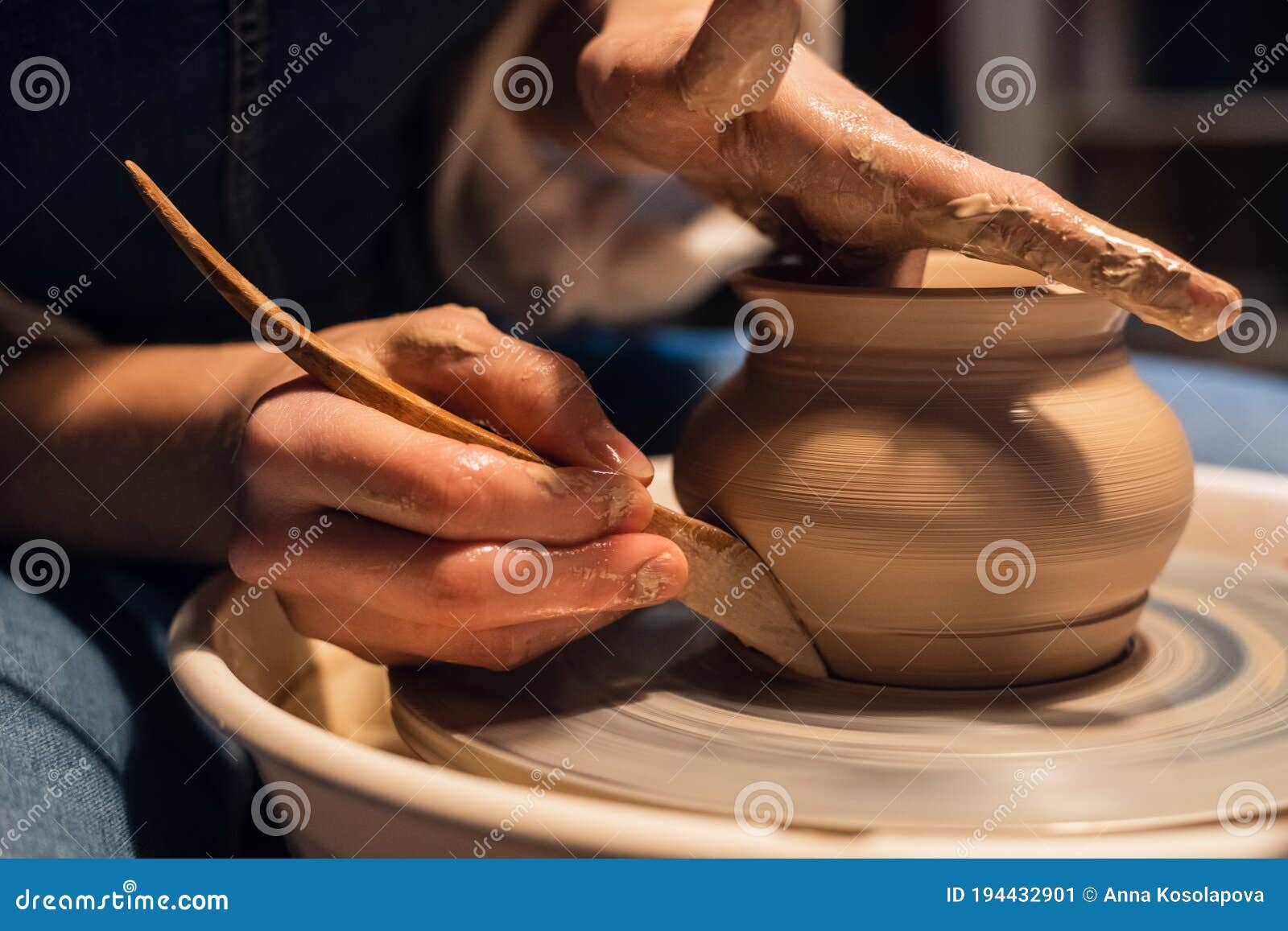 A Master in a Pottery Workshop Shows the Technique of Modeling a Pot on ...