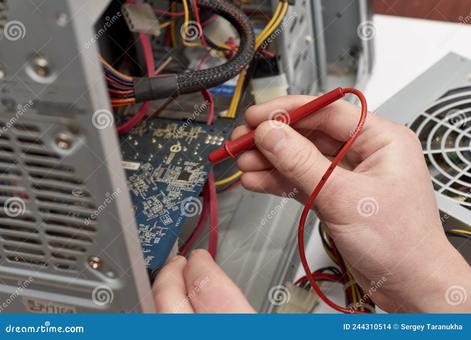 The Master Repairs the Computer Measures the Voltage on the Board with ...