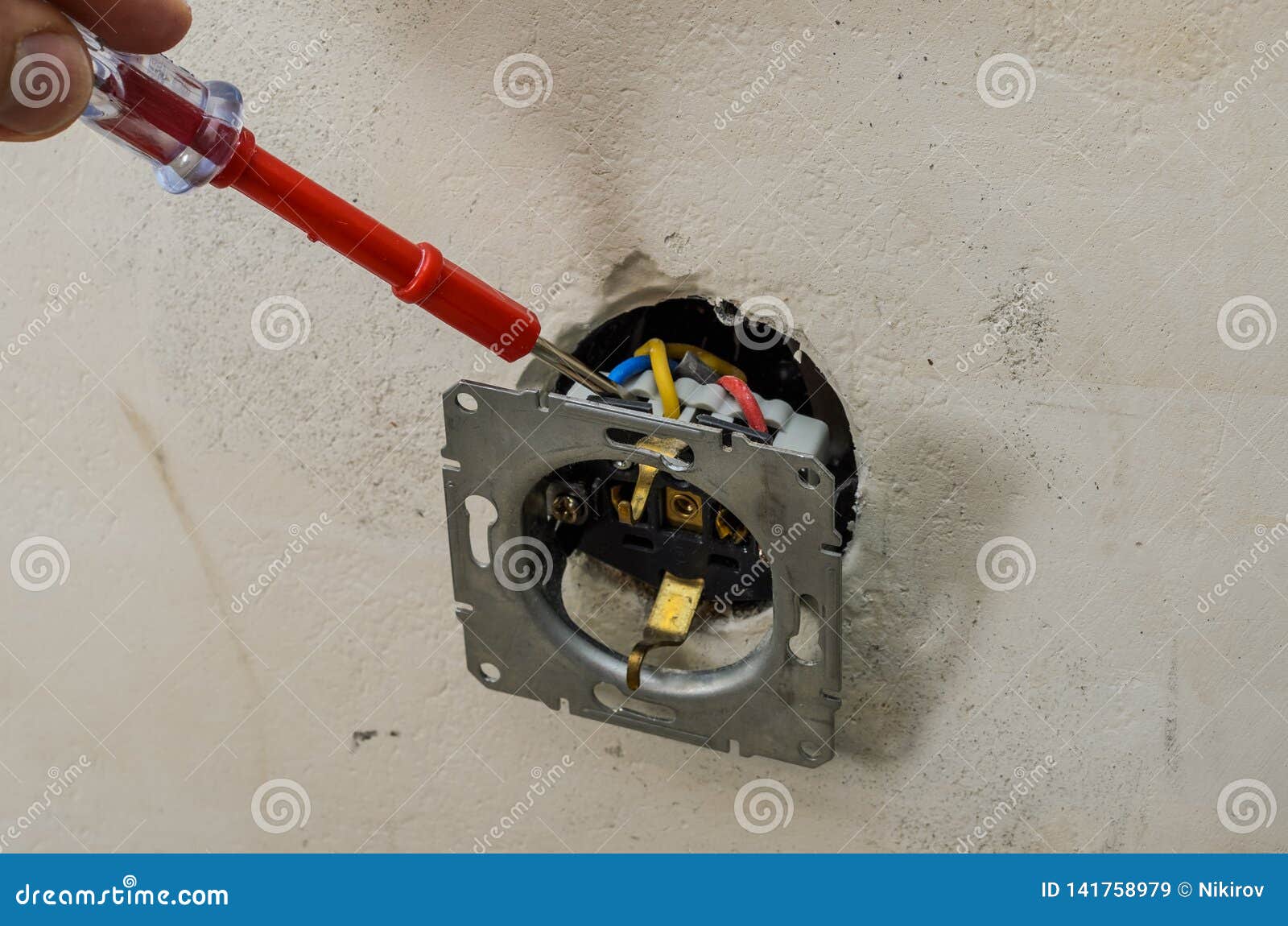 The Master Repairs the Socket with a Screwdriver Installing it into the ...