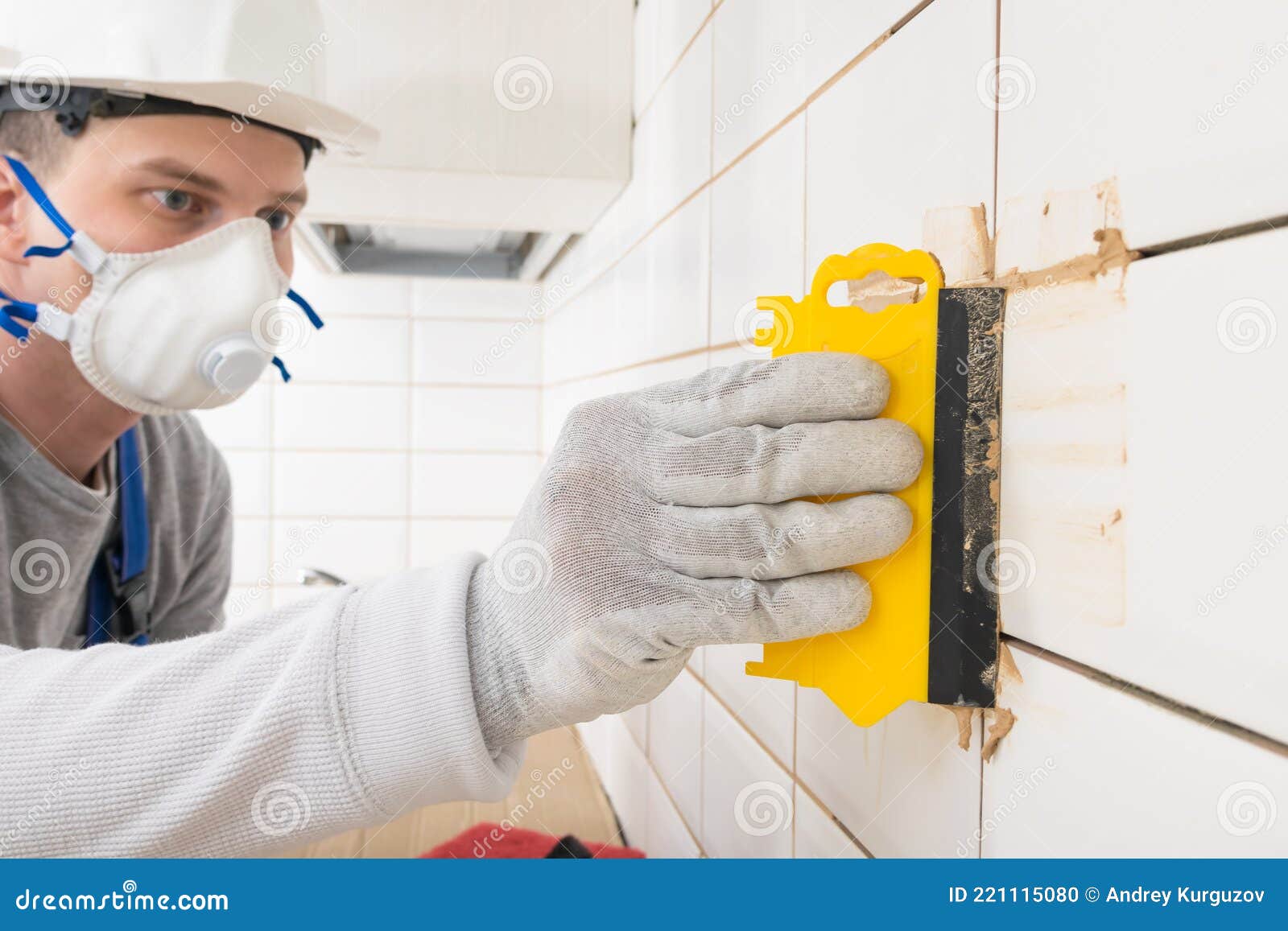 The Master Is Rubbing The Seams Of Tiles On The Floor. Final Finishing ...