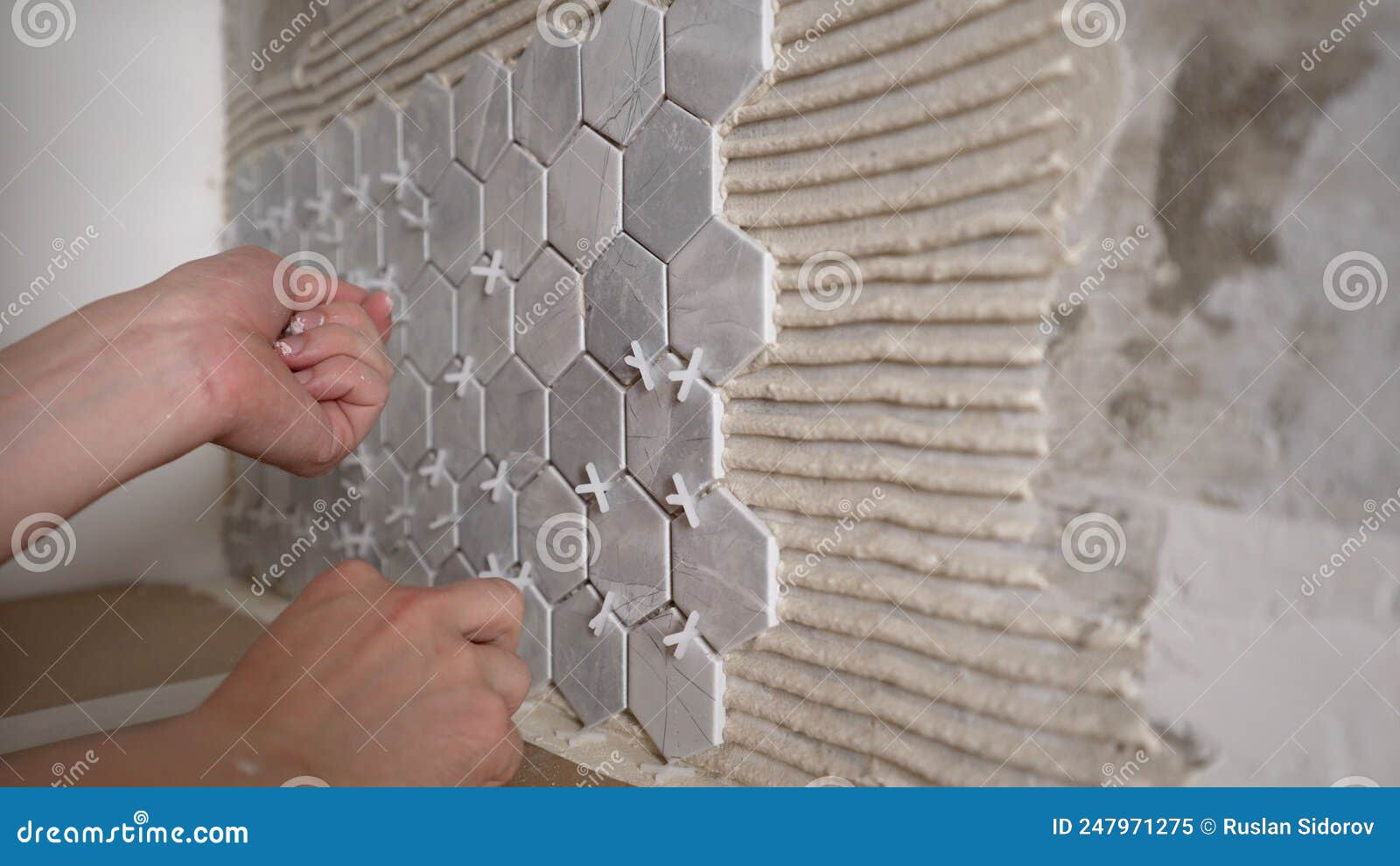 A Worker Installs a Tile Leveling System. Crosses for Ceramic Tiles ...