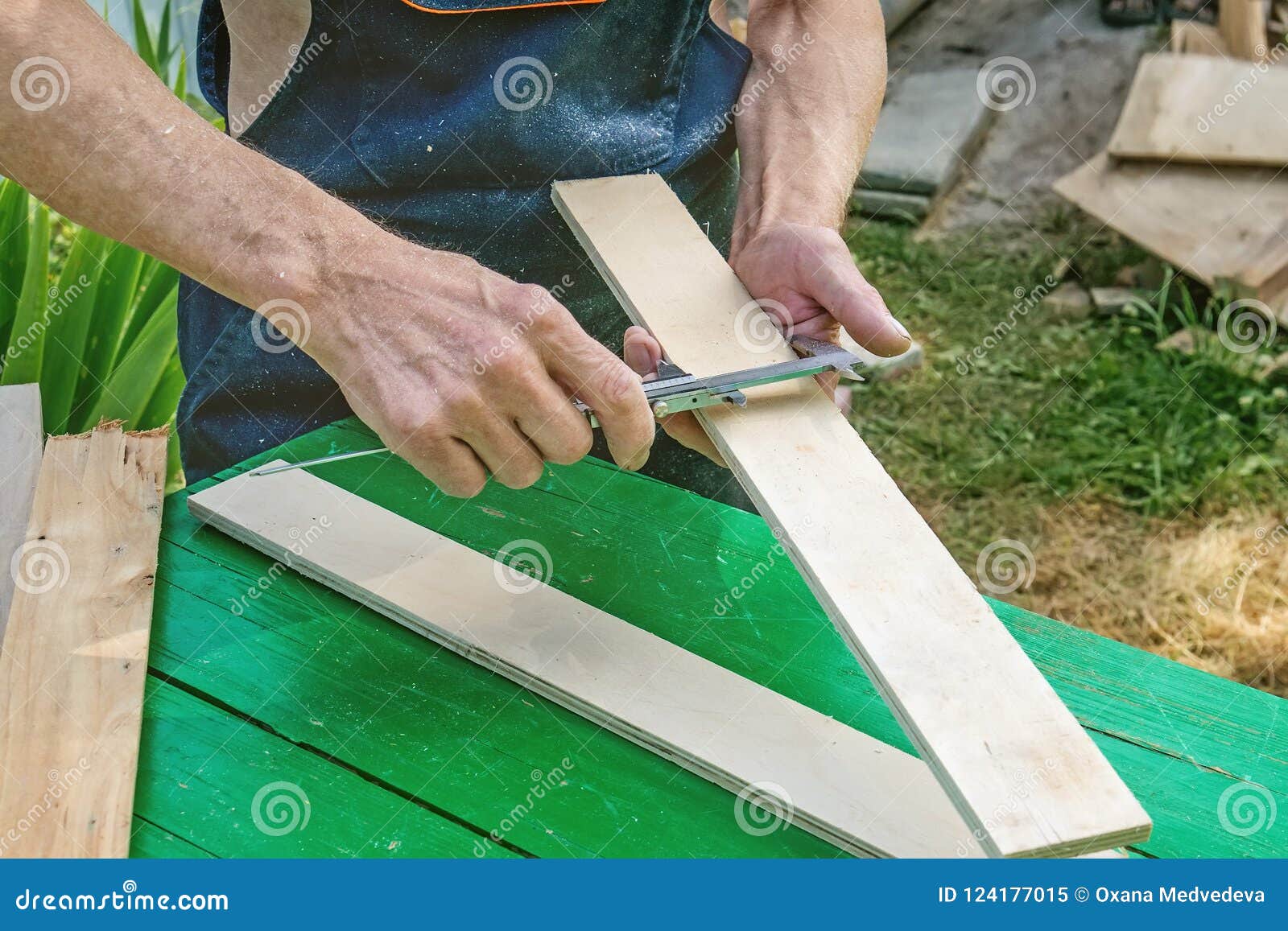 The Master Sharpens The Wooden Panel With An Electric Grinder On A ...