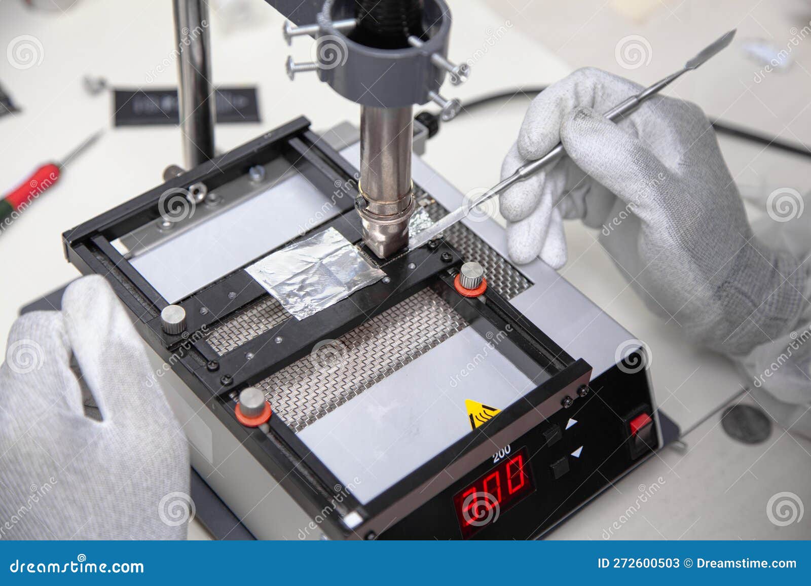 The Master Solders the Microchip at the Soldering Station. Service ...