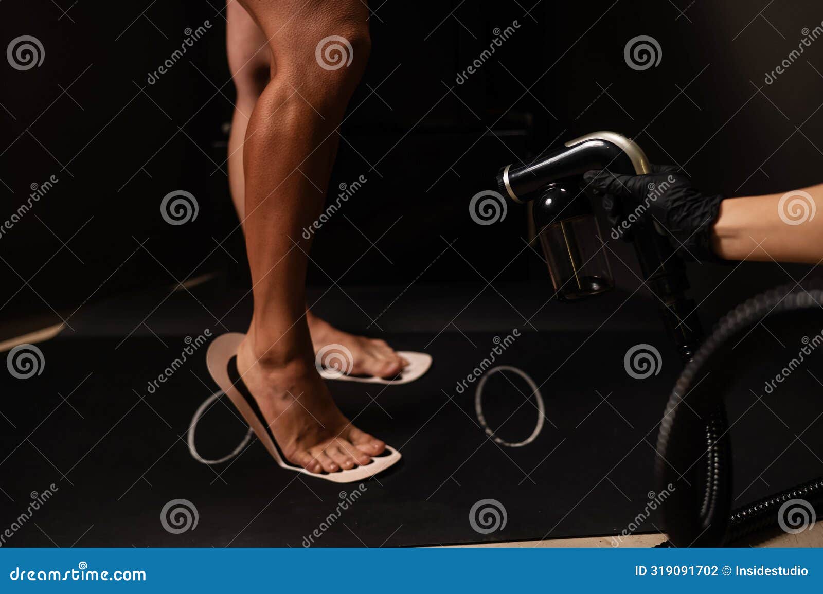 The Master Sprays Bronzer on the Clients Legs. Instant Tan. Stock Photo ...