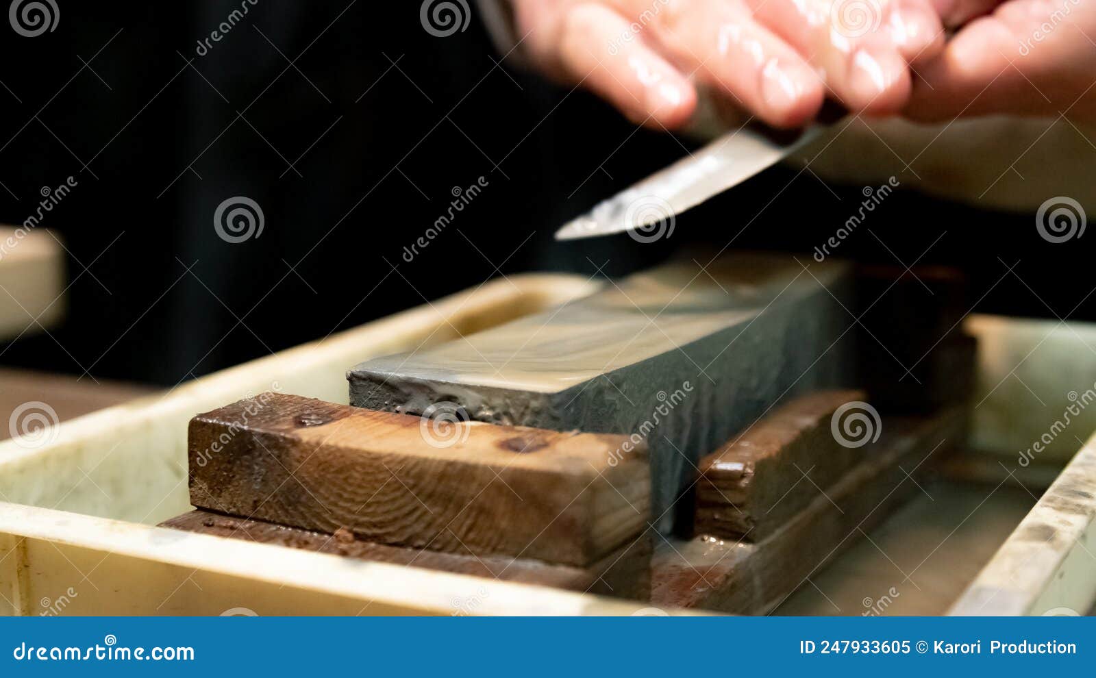 Master Swordsmith is Sharpening Knife on Grindstone with Water Stock ...
