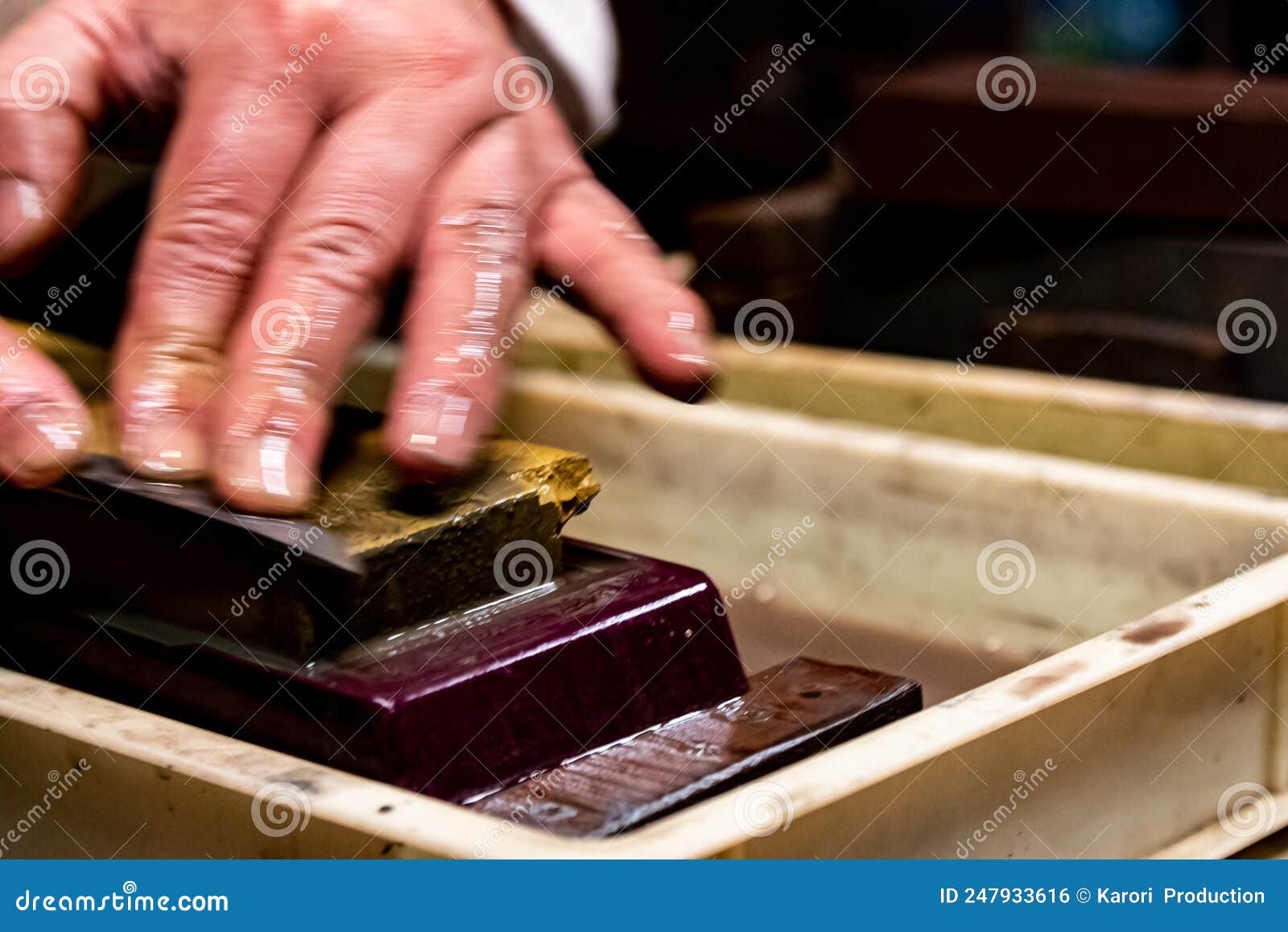 Master Swordsmith is Sharpening Knife on Grindstone with Water Stock ...