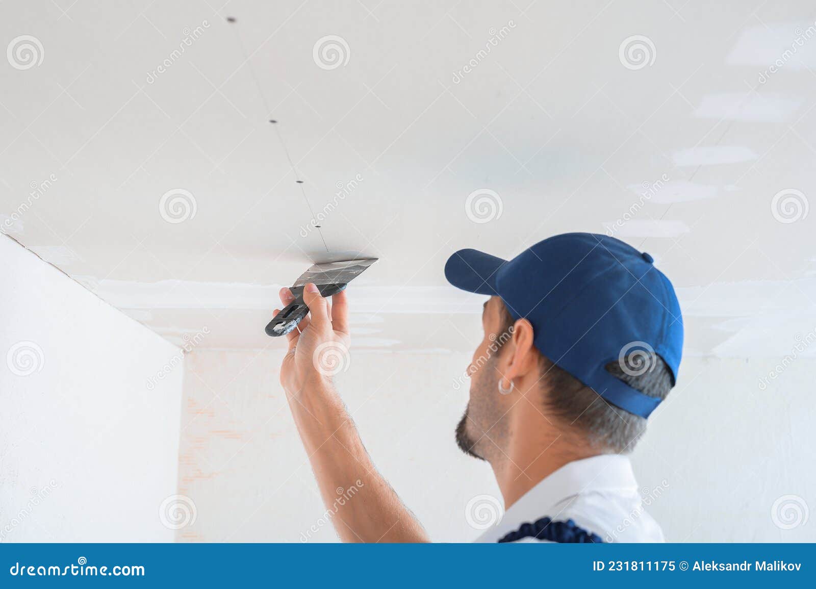 A Master in Uniform Puts Putty on the Caps of Self-tapping Screws for ...