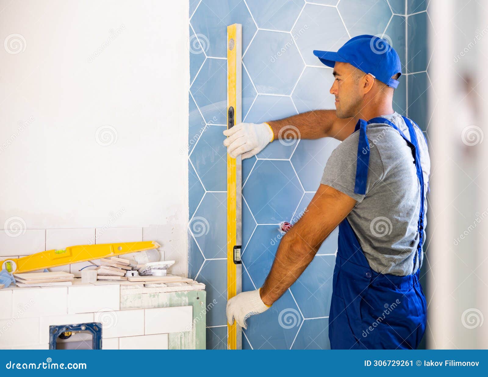 Master Wearing Work Clothes Checking Vertical of Installing Tiles Using ...