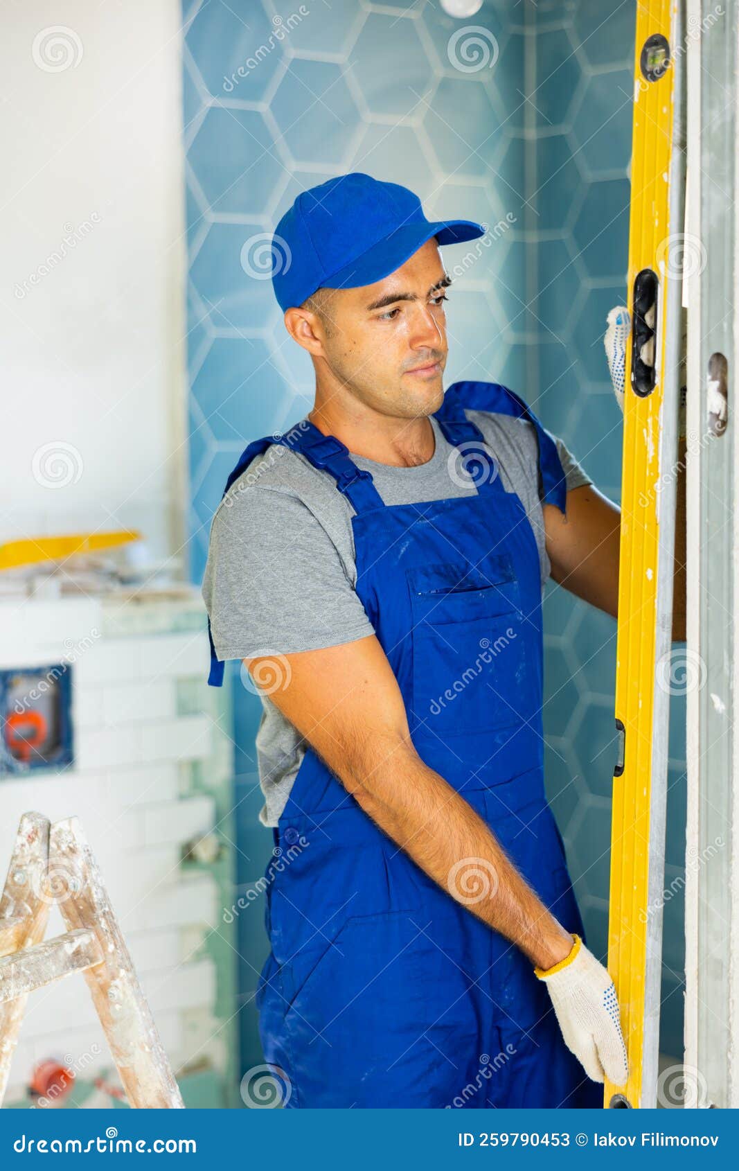 Master Wearing Work Clothes Checking Vertical of Installing Tiles Using ...