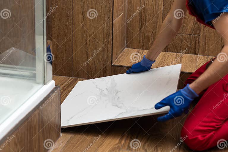 Master is Wearing Work Clothes, is Checking Horizon of Installing Tiles ...